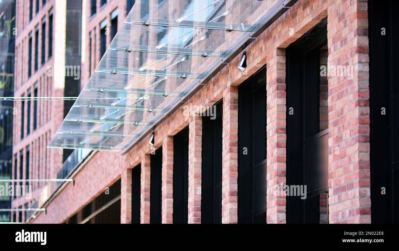 Modern brick and glass facade of the office building. A contrasting ...