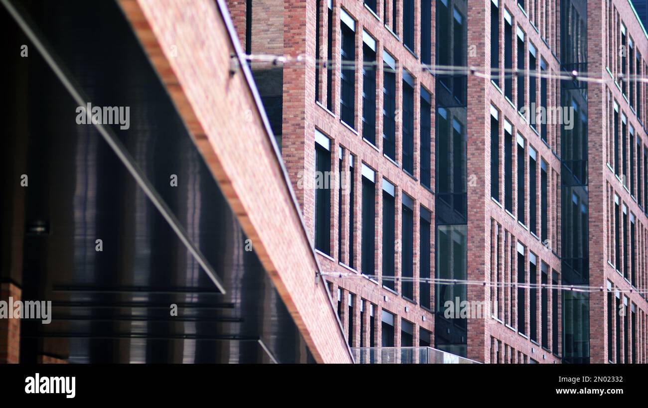 Modern brick and glass facade of the office building. A contrasting ...