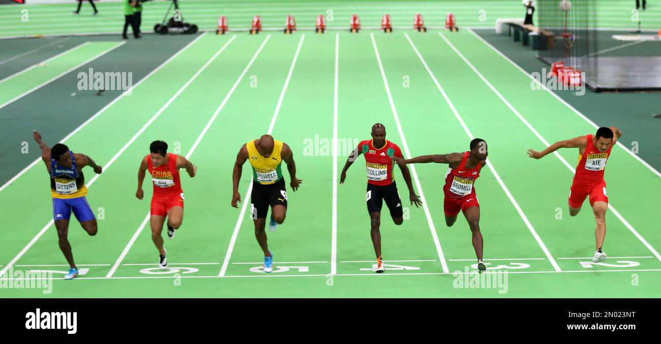 United States' Trayvon Bromell, second from right, crosses the finish ...