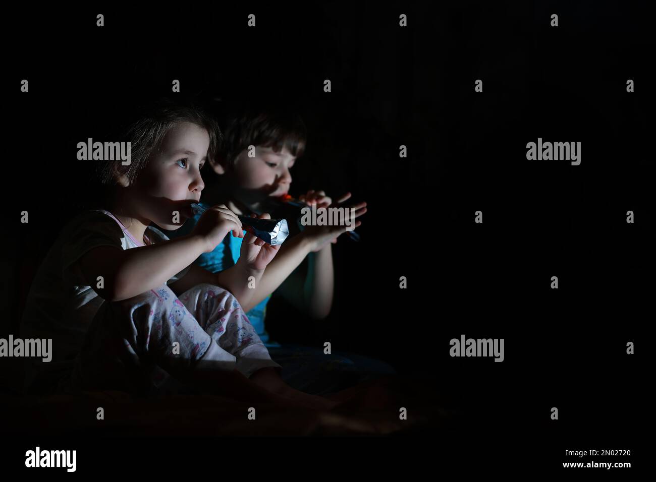Small children in a dark room watching TV at night Stock Photo - Alamy