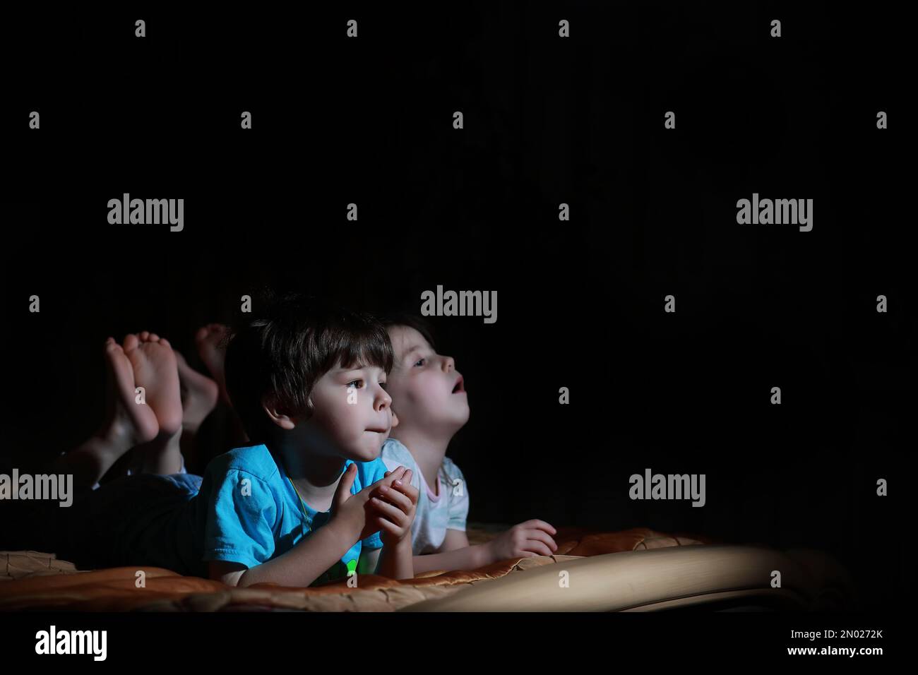 Small children in a dark room watching TV at night Stock Photo - Alamy