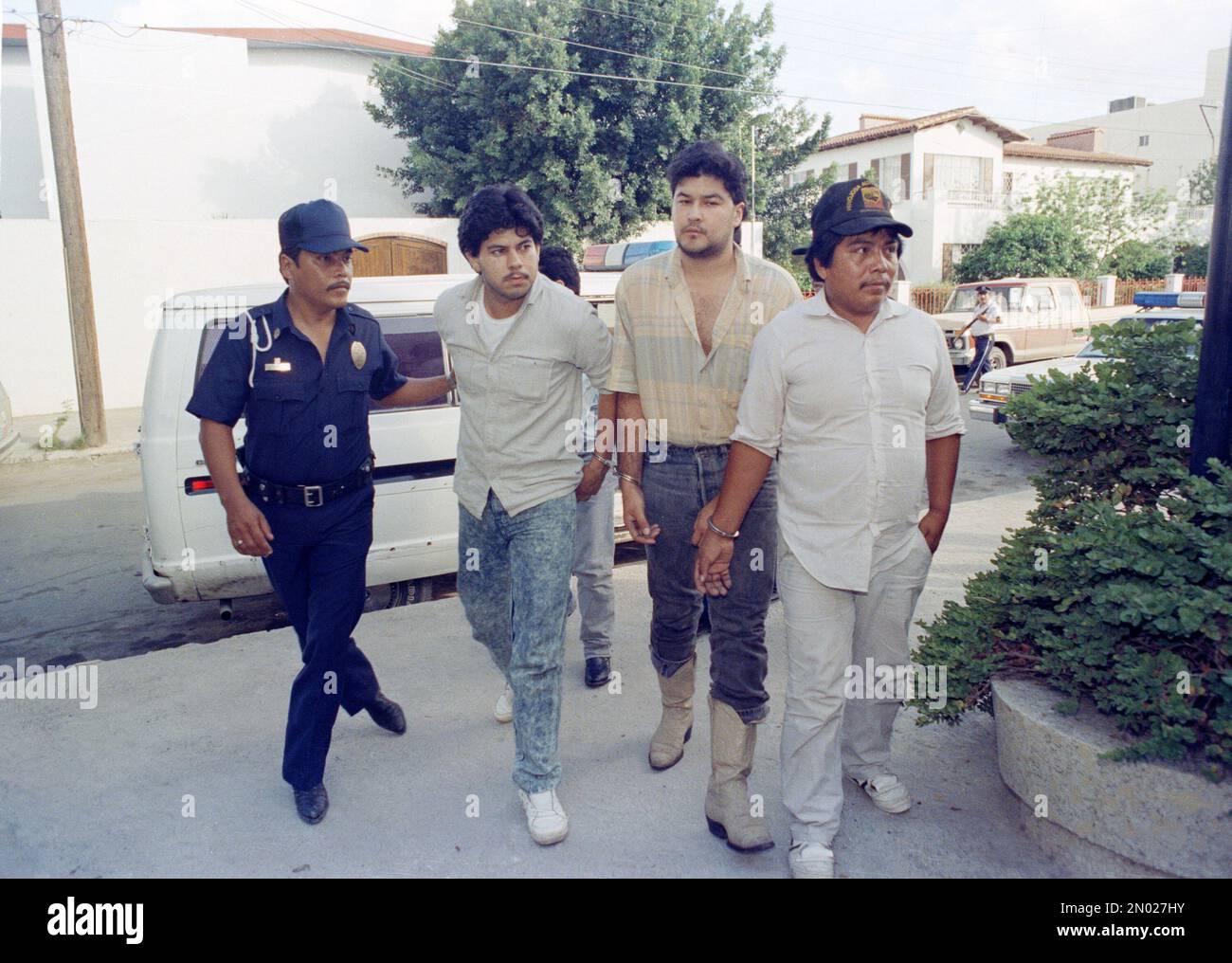 Police escort the four suspects for the cult murders to their ...