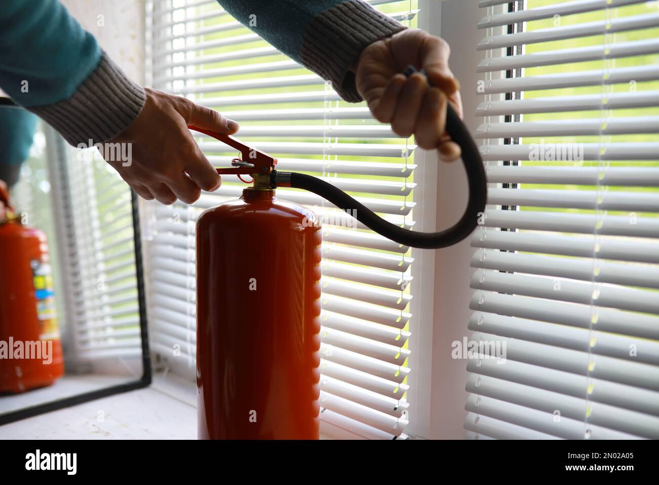 hand presses the trigger fire extinguisher available in fire ...