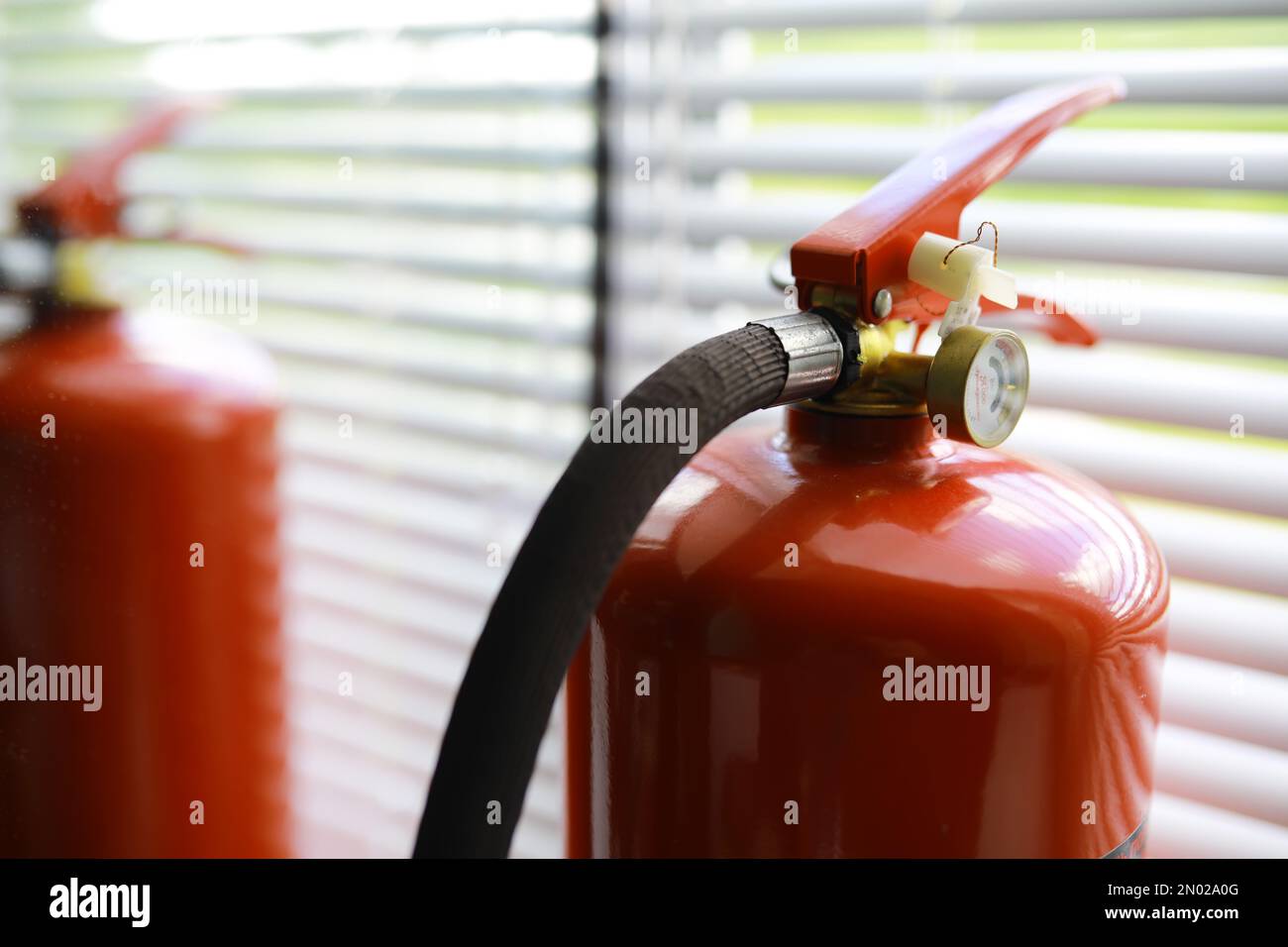 hand presses the trigger fire extinguisher available in fire ...