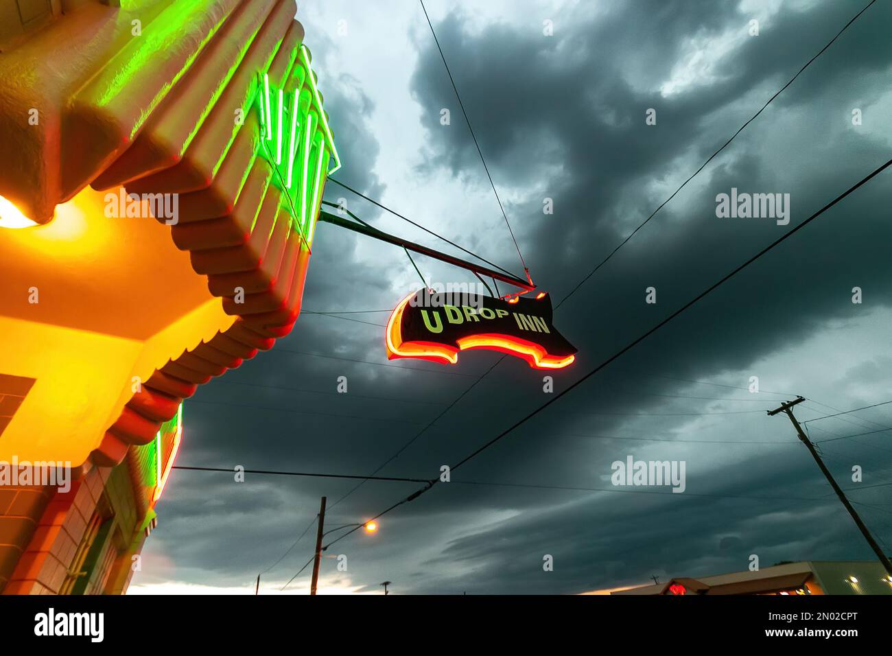 illuminated neon sign and dramatic stormy sky at iconic U drop inn on ...