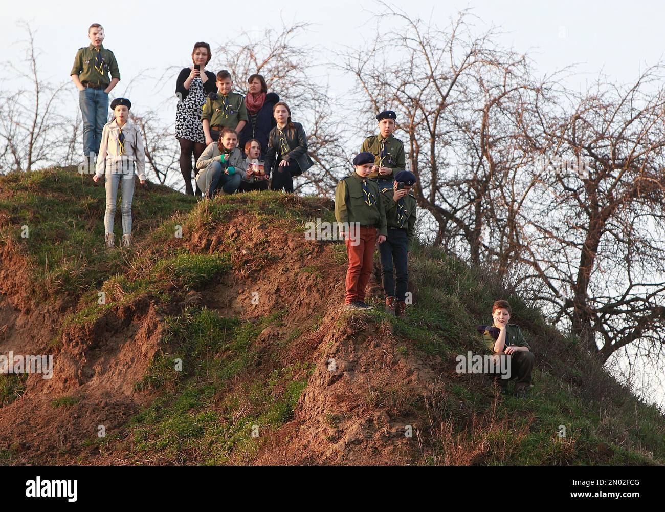 Local residents and scouts watch the ceremony to officially open the ...
