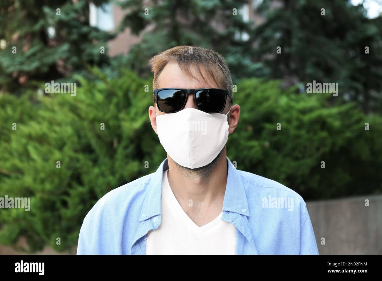 Man wearing handmade cloth mask outdoors. Personal protective equipment ...