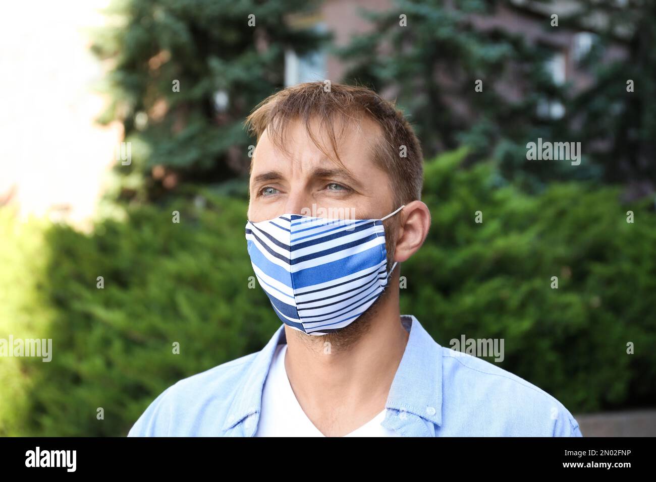 Man wearing handmade cloth mask outdoors. Personal protective equipment ...