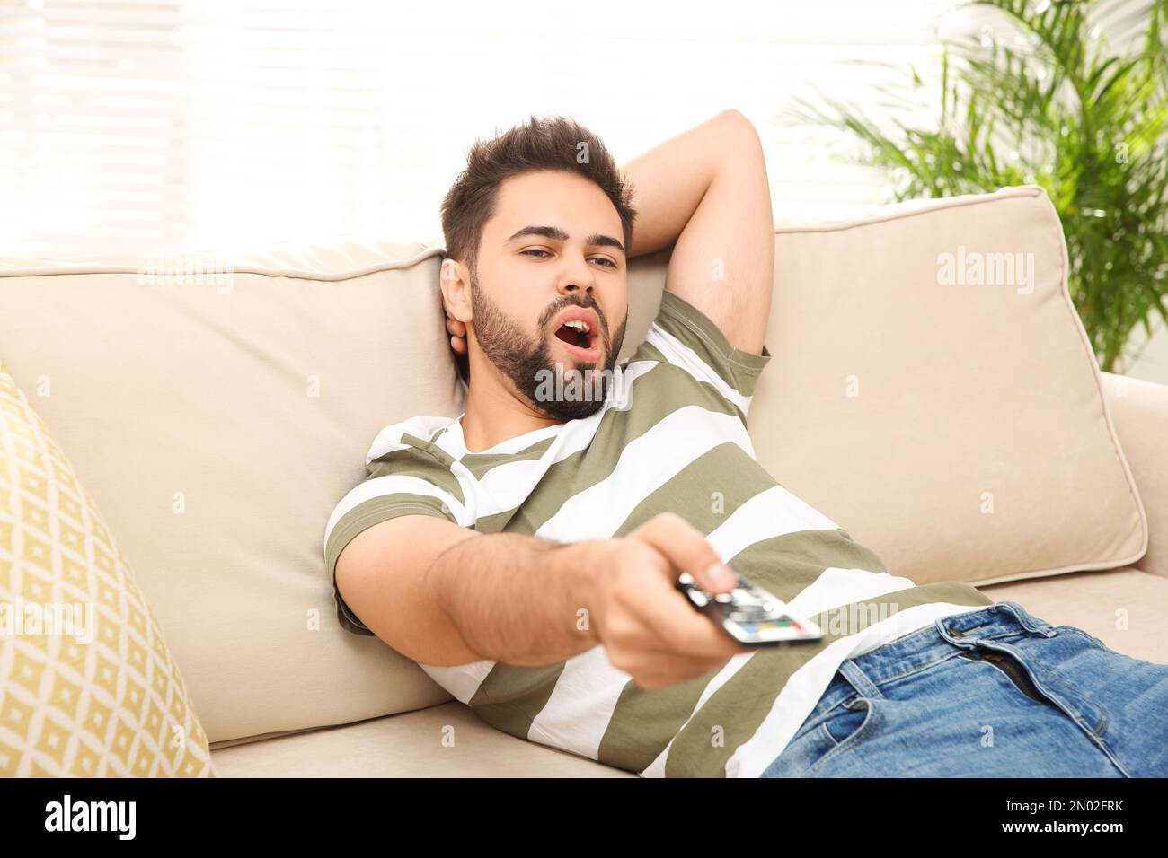 Lazy guy on couch watching hi-res stock photography and images - Alamy