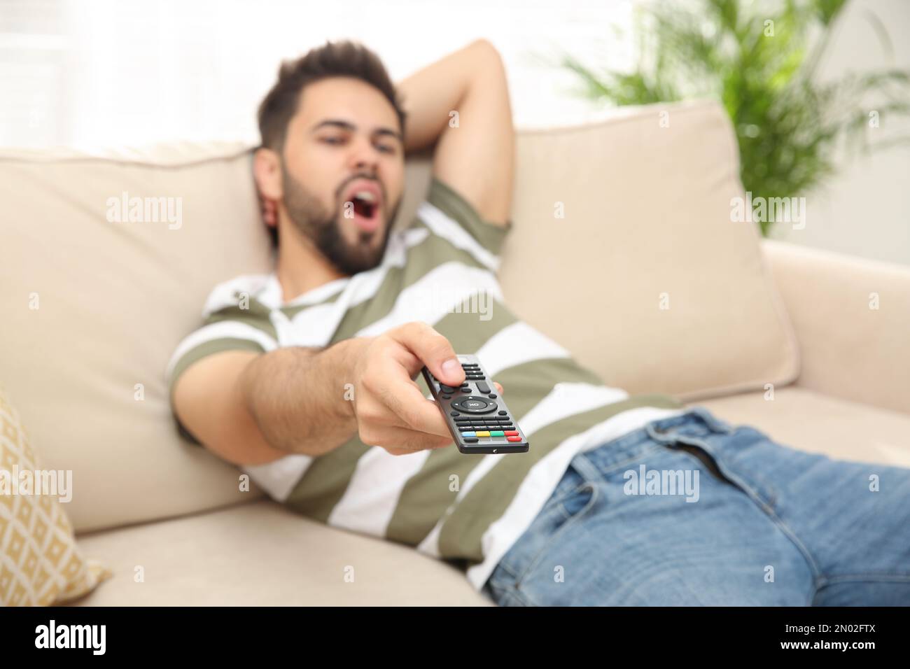 Lazy guy on couch watching hi-res stock photography and images - Alamy