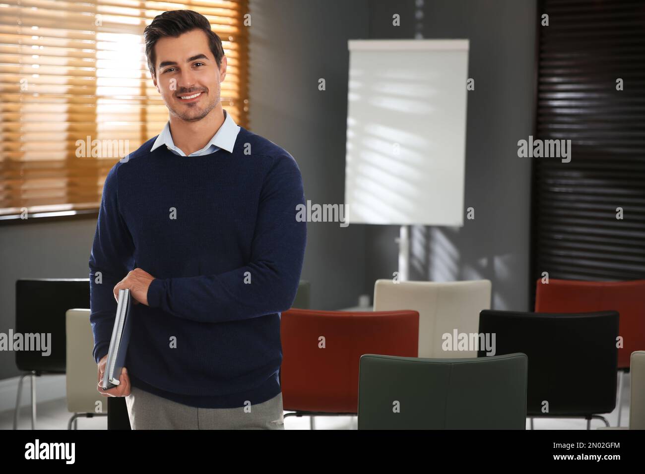 Young teacher waiting for students in classroom Stock Photo - Alamy