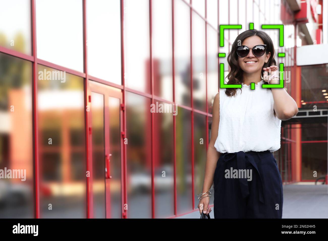 Facial recognition system identifying woman on city street Stock Photo ...