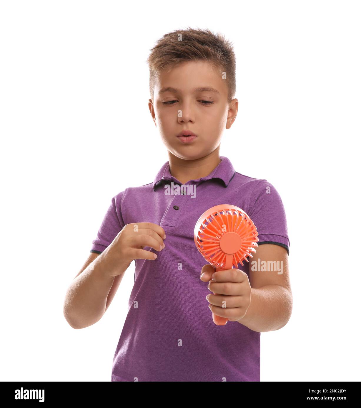 Little boy with portable fan suffering from heat on white background ...