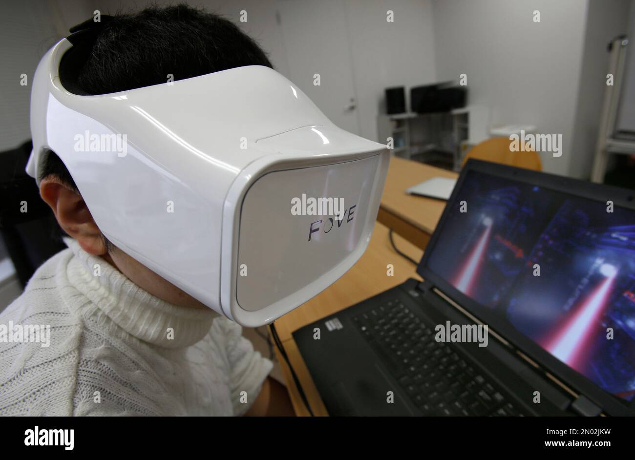 In this March 7, 2016 photo, Fove's staff wearing an eye-tracking ...