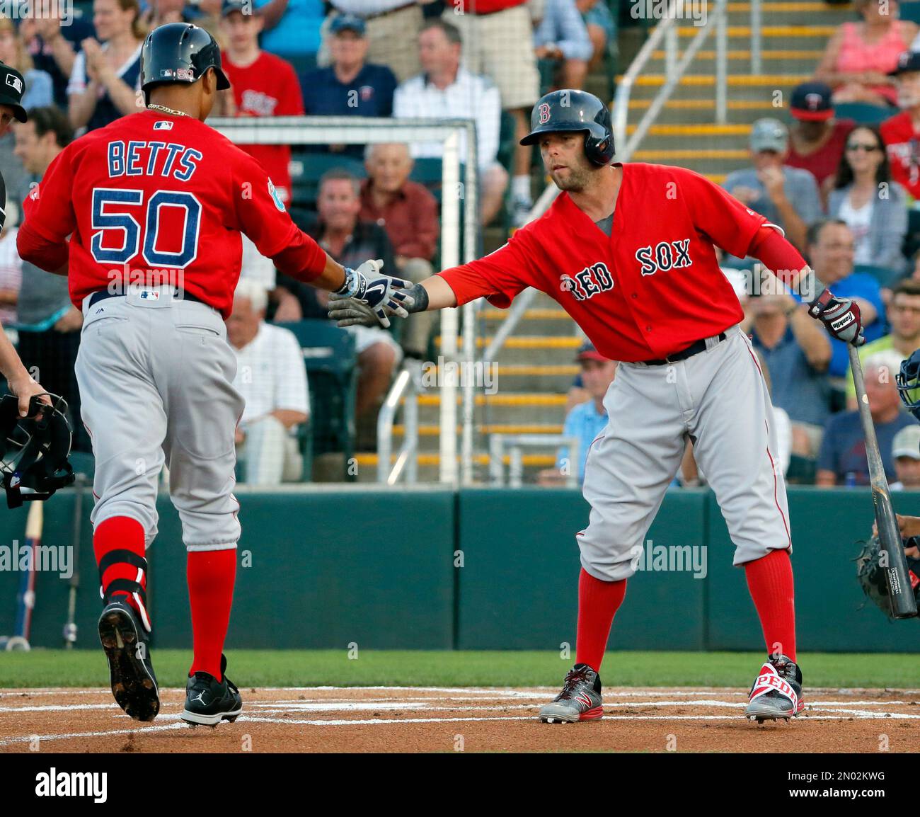 Boston Red Sox's Mookie Betts (50) is congratulated by Dustin Pedroia ...