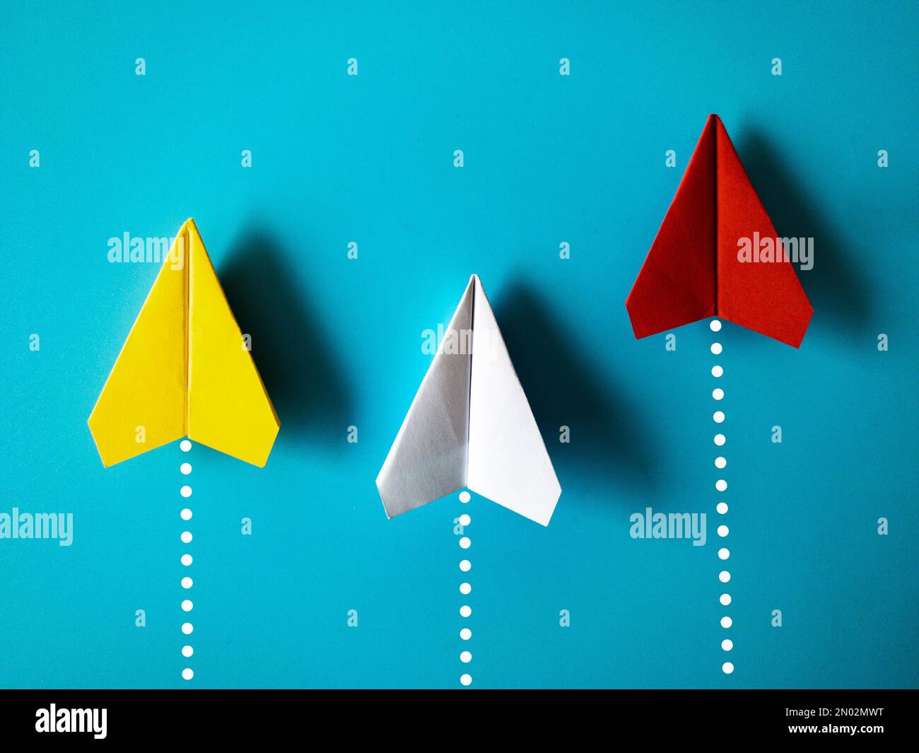 Yellow, white and red paper airplane origami racing to achieve ...