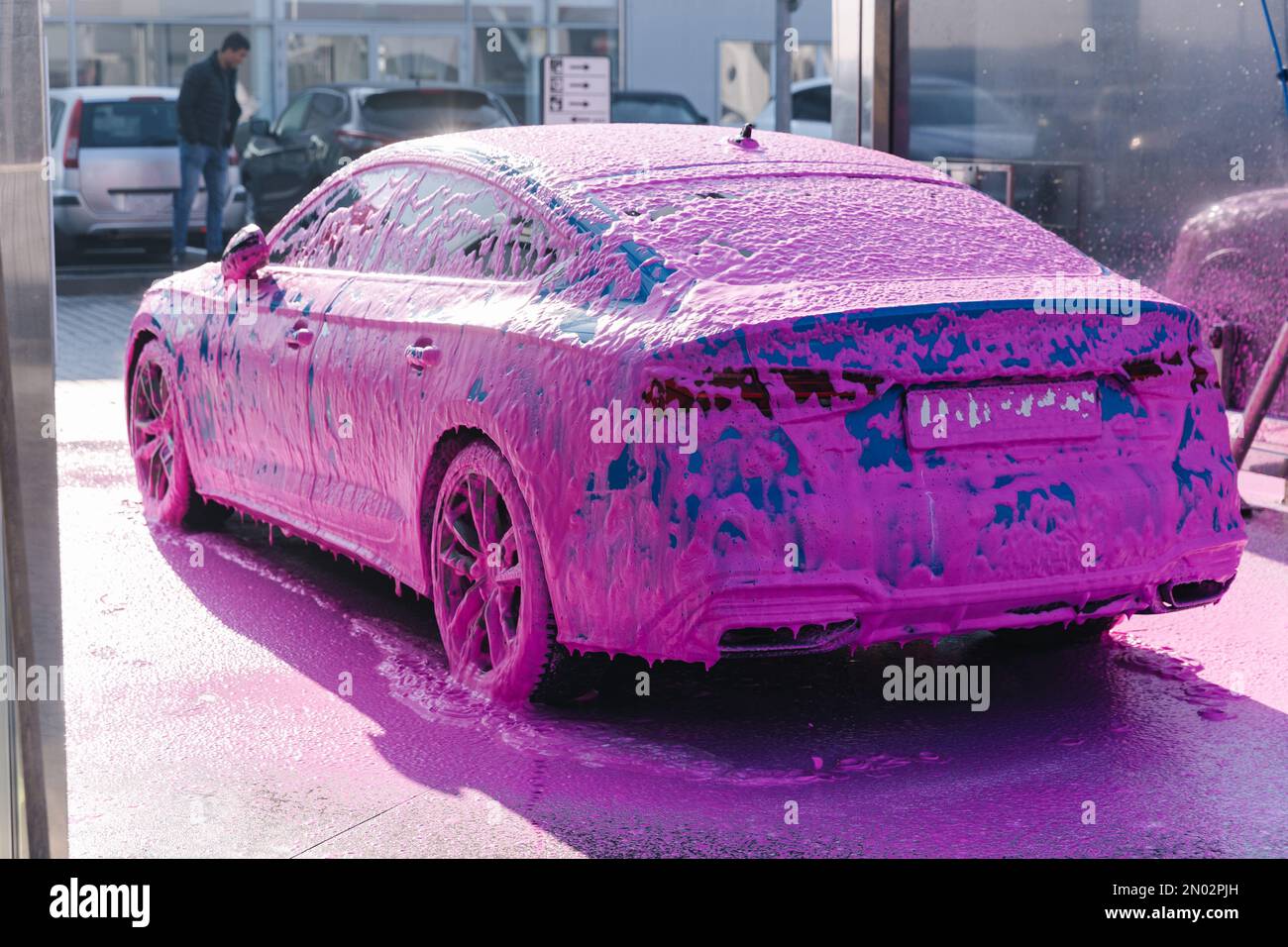 Luxury sport blue car on self servise car washing. Pink foam on auto ...