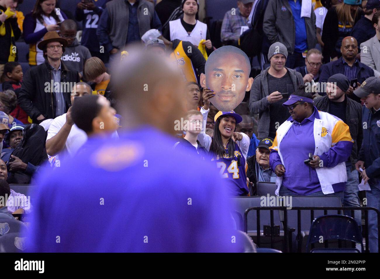 Los Angeles Lakers forward Kobe Bryant (foreground) warms up as a fan ...