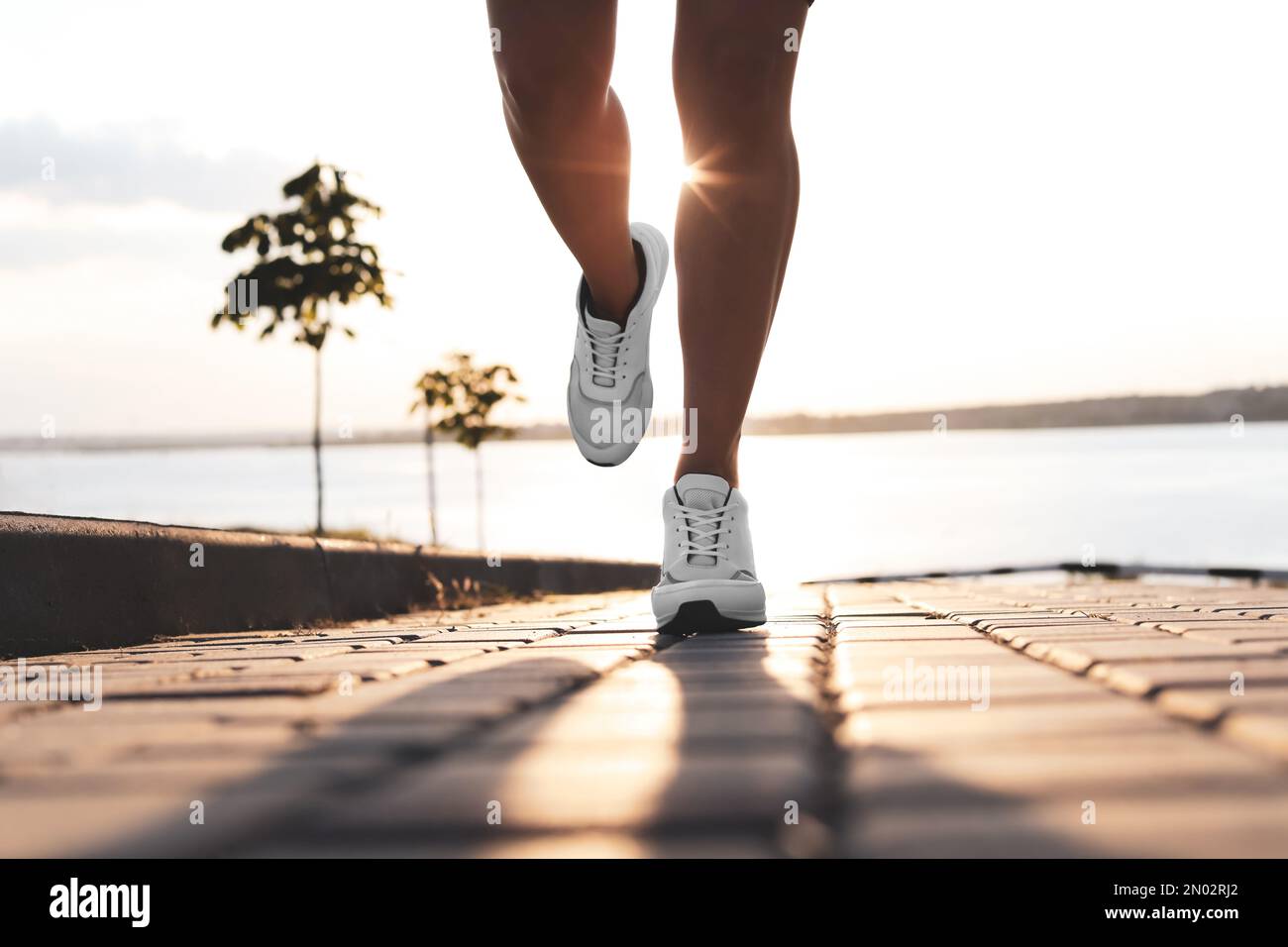 Young woman jogging near river hi-res stock photography and images - Alamy