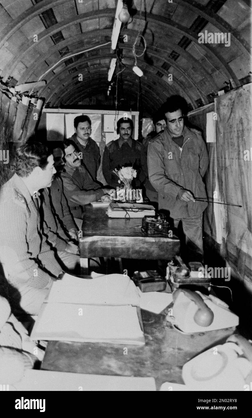 Iraq's President Saddam Hussein listens to explanations on a map of the ...