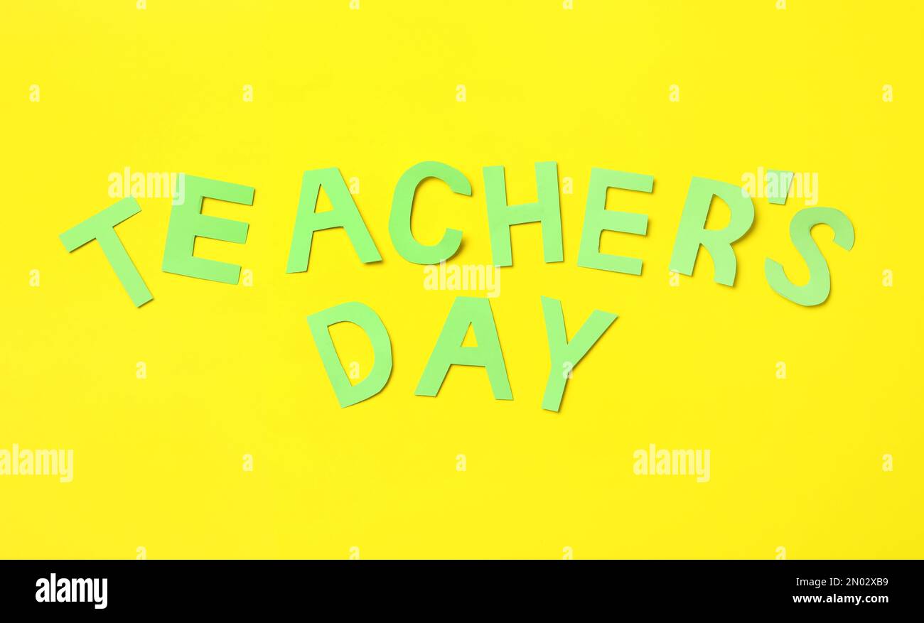 Words TEACHER'S DAY on yellow background, flat lay Stock Photo - Alamy
