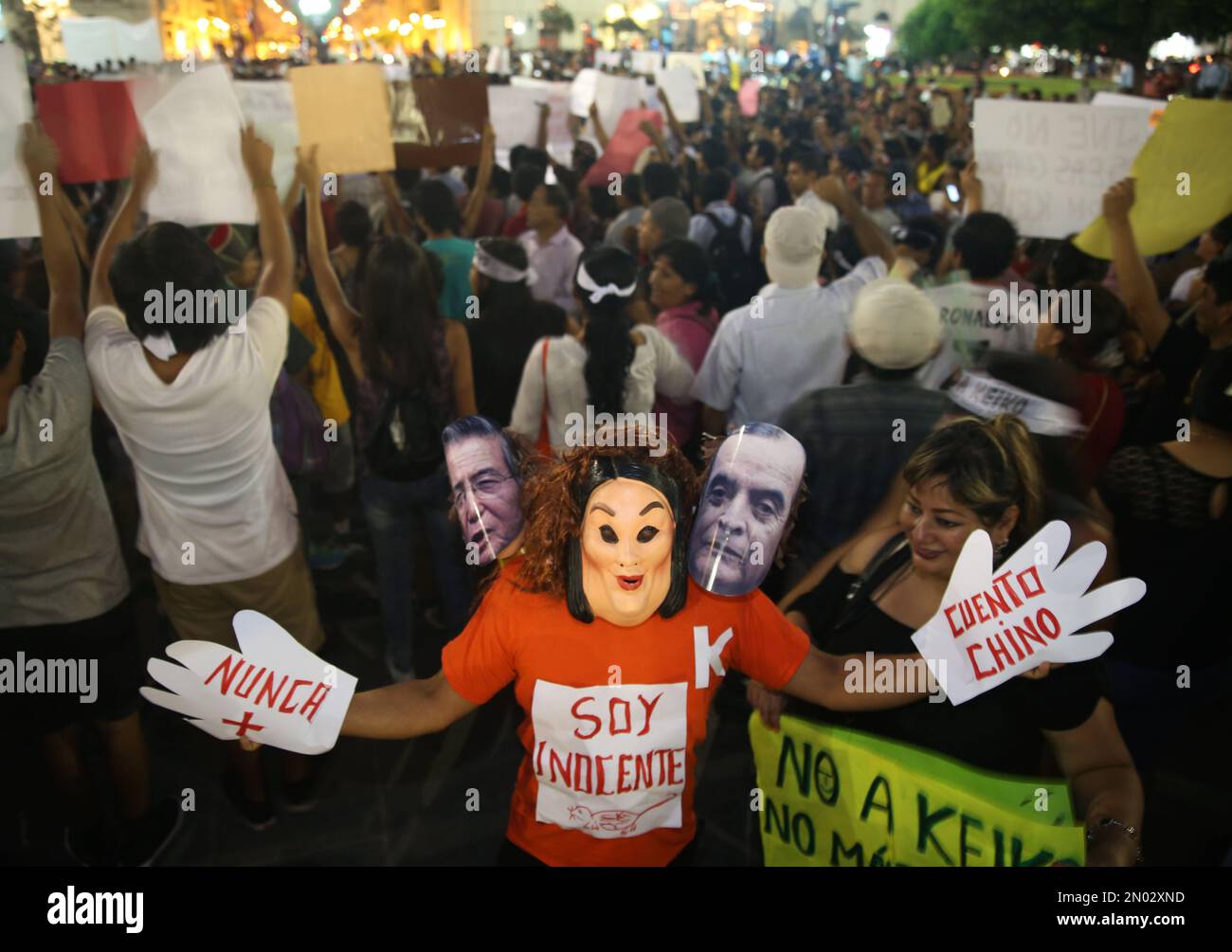 A demonstrator wearing a Keiko Fujimori mask strikes a pose for the ...