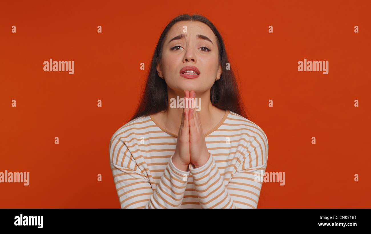 Please, God, forgive me. Young woman sincerely praying to God and ...