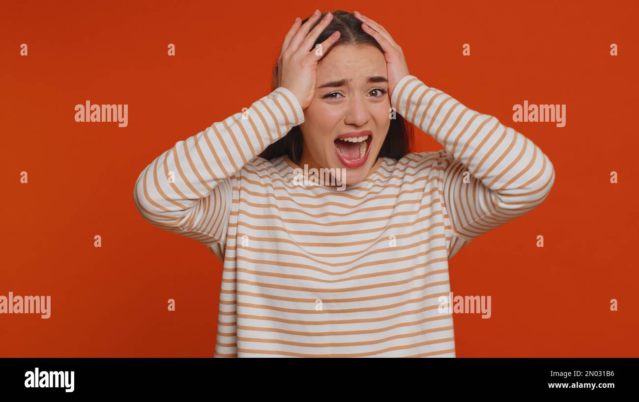 Young woman in pullover screams from stress tension problems feels ...