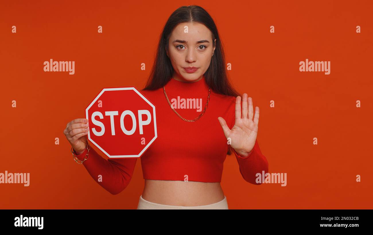 Serious pretty woman say No, hold inscription text red No stop danger ...