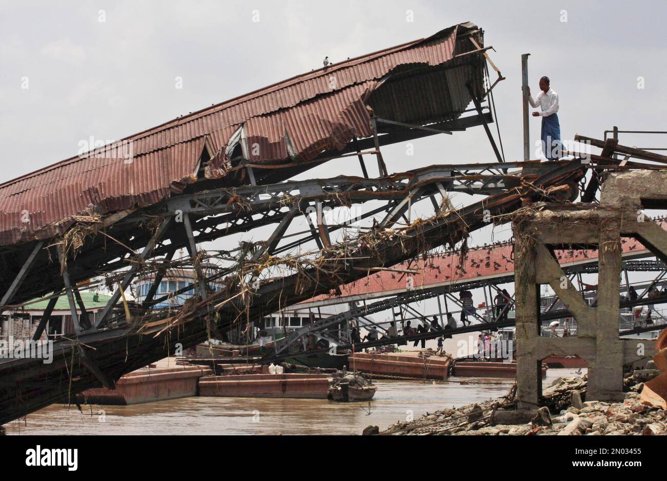 FILE - In this May 7, 2008, file photo, a man stands at the broken pier ...