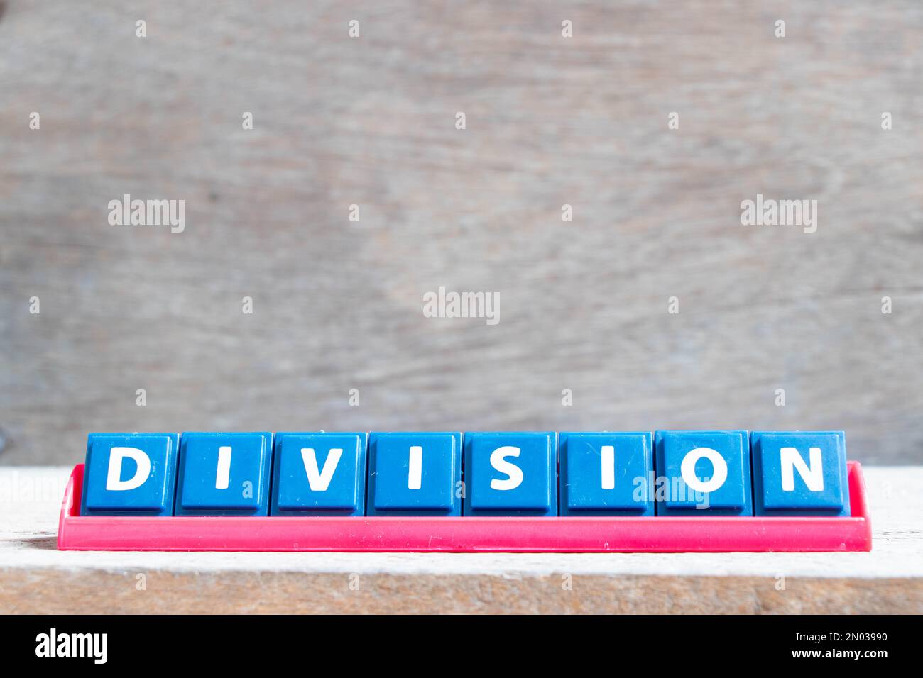 Tile alphabet letter with word division in red color rack on wood ...