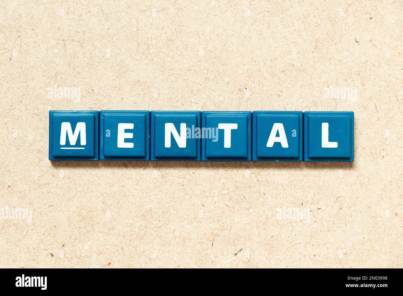Tile alphabet letter in word mental on wood background Stock Photo - Alamy