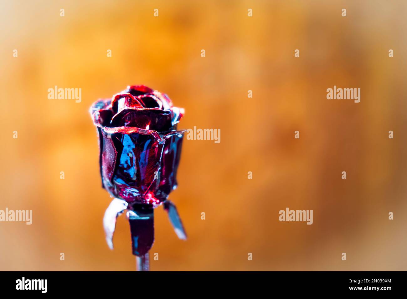 Painted shiny metal roses with brown background Stock Photo - Alamy