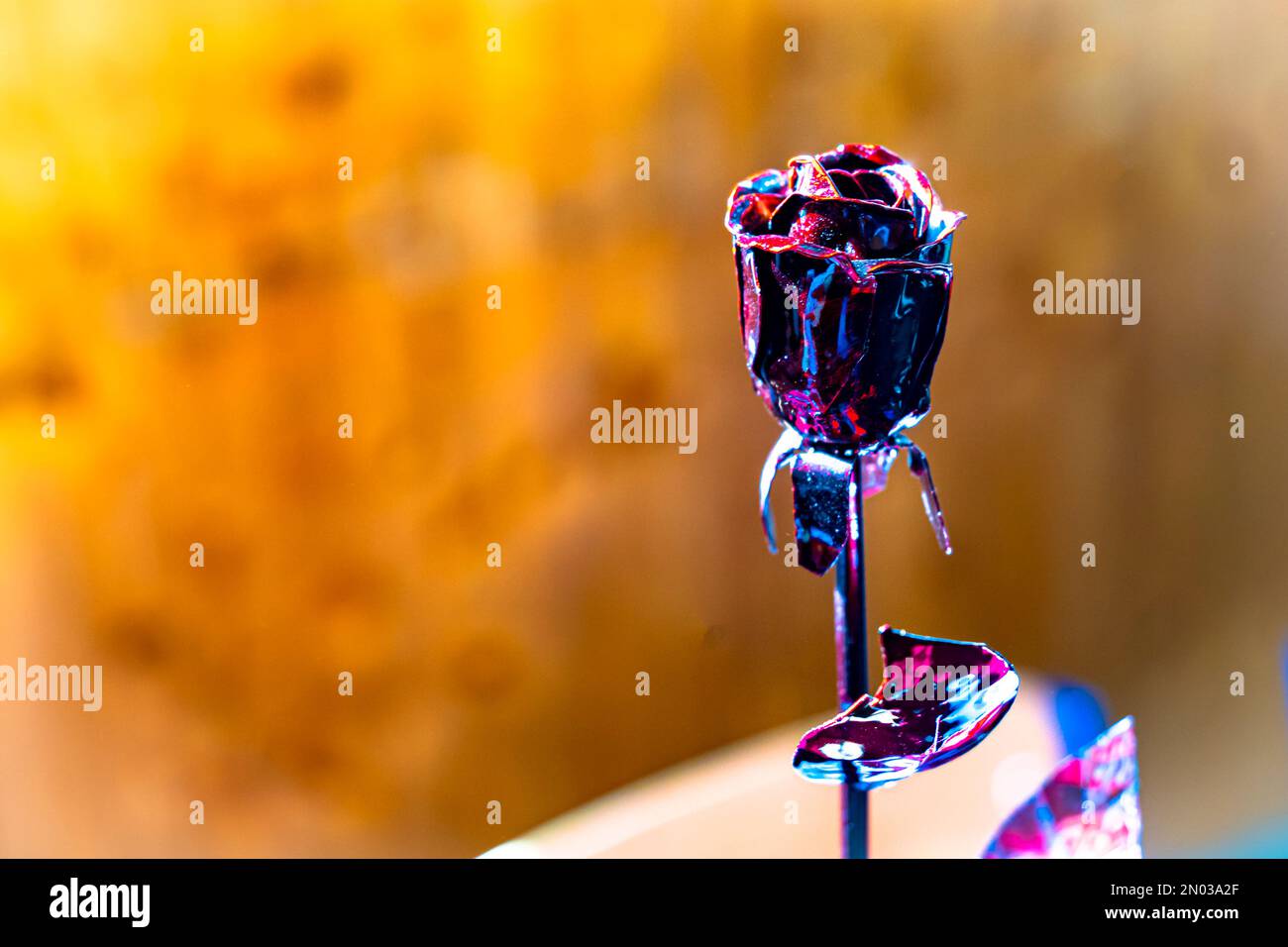 Painted shiny metal roses with brown background Stock Photo - Alamy