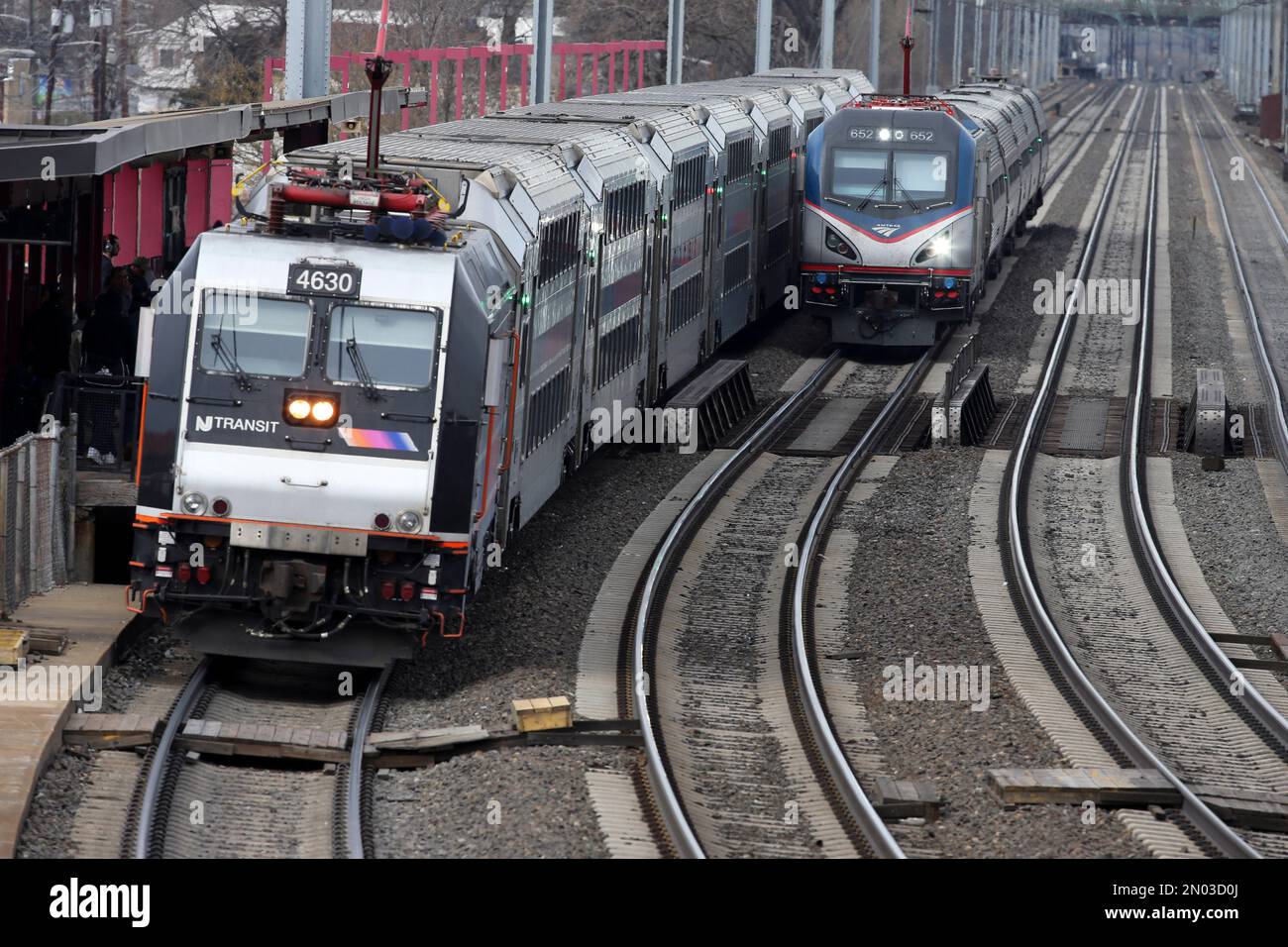 An Amtrak train passes a New Jersey Transit train stopped to discharge ...