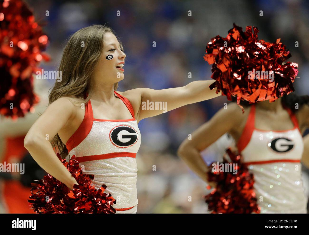 A Georgia cheerleader performs during the first half of an NCAA college ...