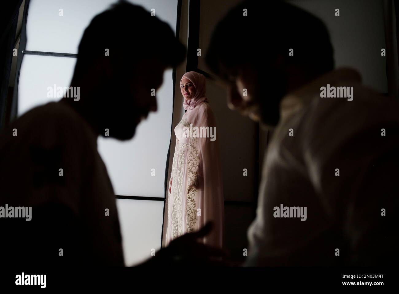 An Iraqi model, center, waits for her turn on the catwalk at the ...