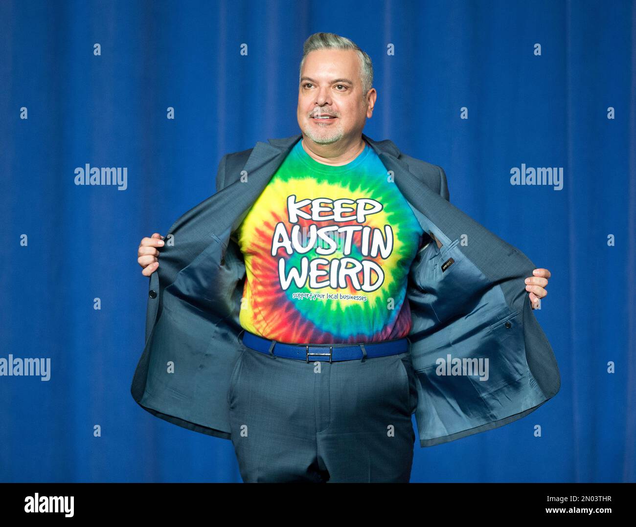 DNC Finance Chairman Henry Munoz, opens up his suit jacket to reveal ...