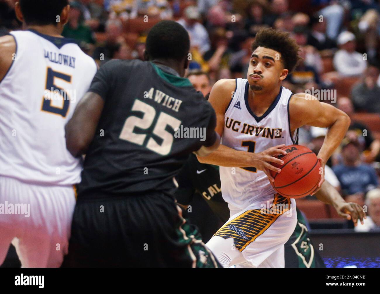 UC Irvine guard Alex Young drives the lane against Cal Poly during the ...