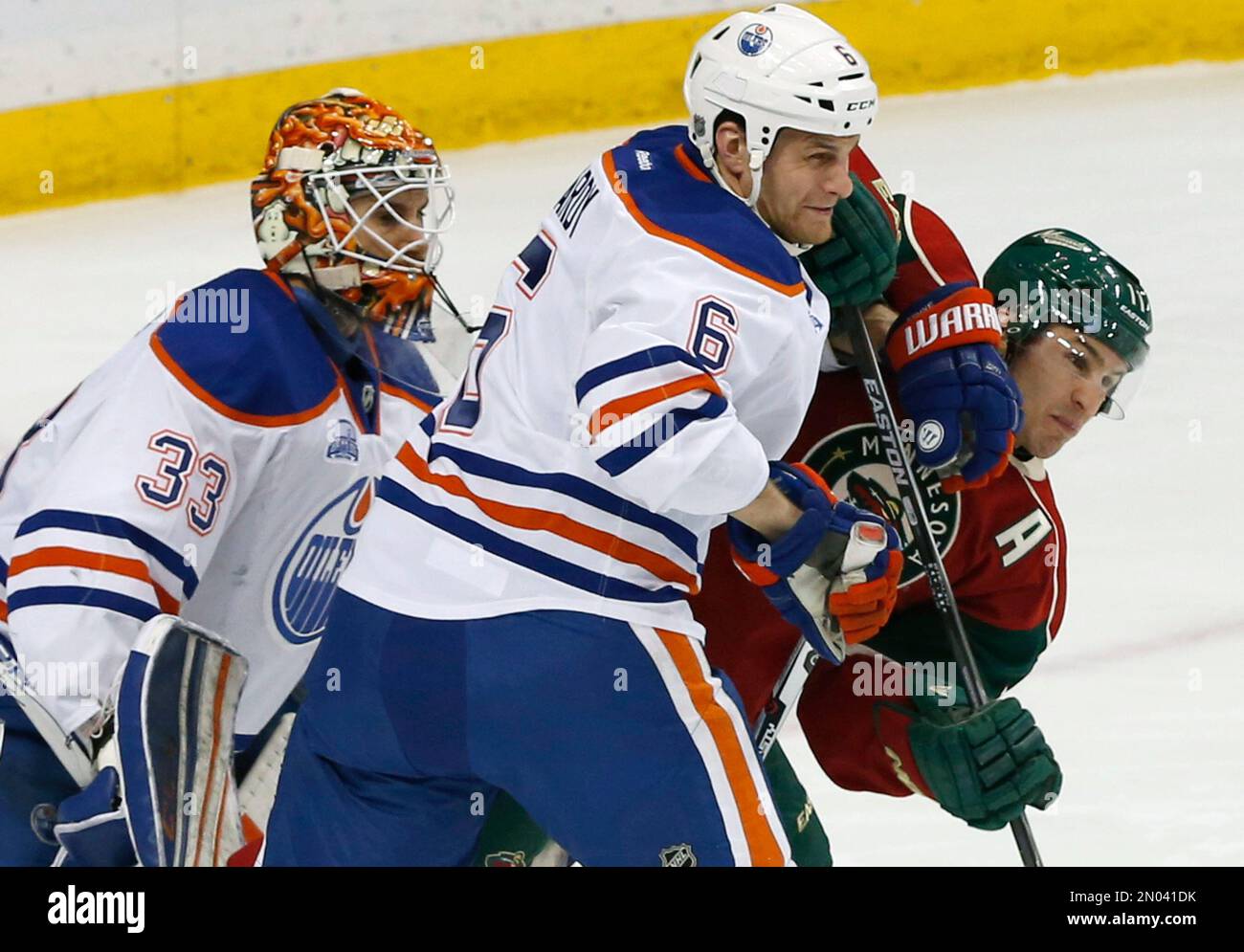 Edmonton Oilers goalie Cam Talbot, left, looks on as teammate Adam ...