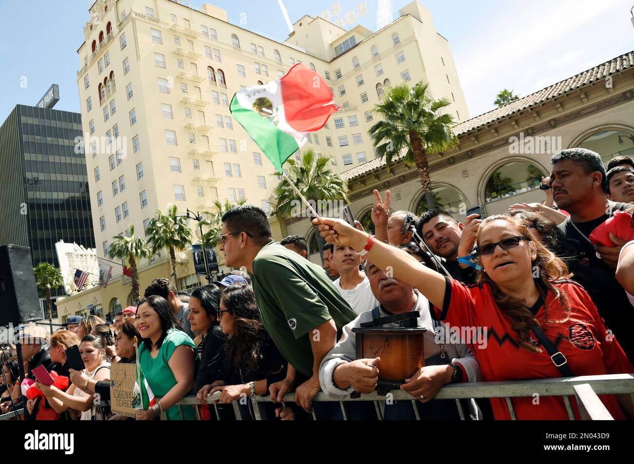 Alma Castillo, right, of Oaxaca, Mexico, waves a Mexican flag during a ...