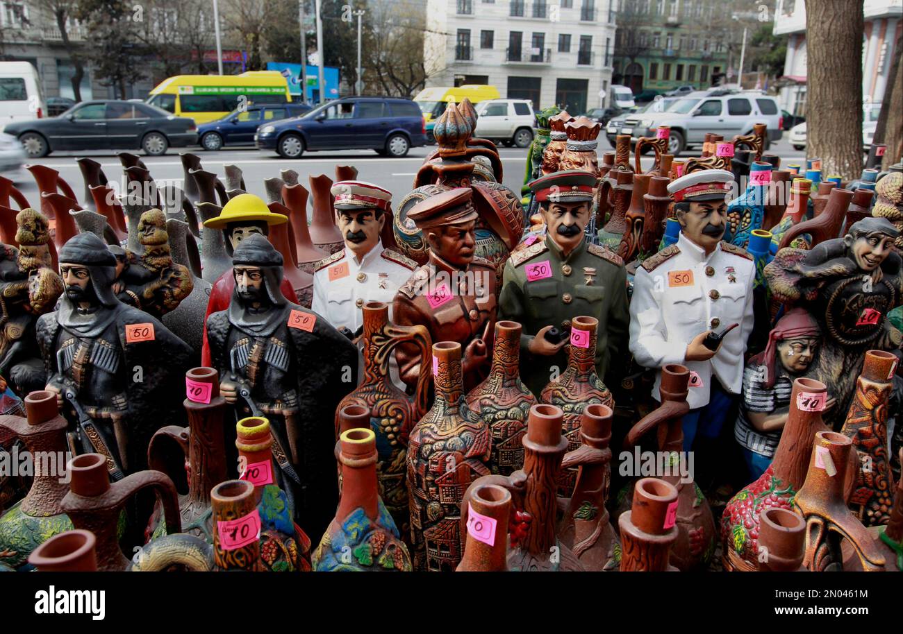 Jugs and dolls are on a display for sale, mainly of Soviet dictator ...