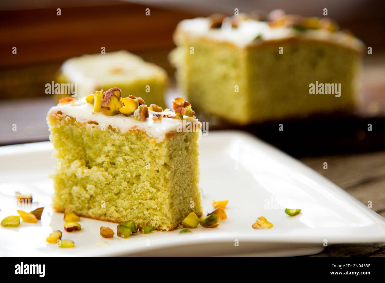 Pistachio sponge cake covered in icing sugar Stock Photo - Alamy