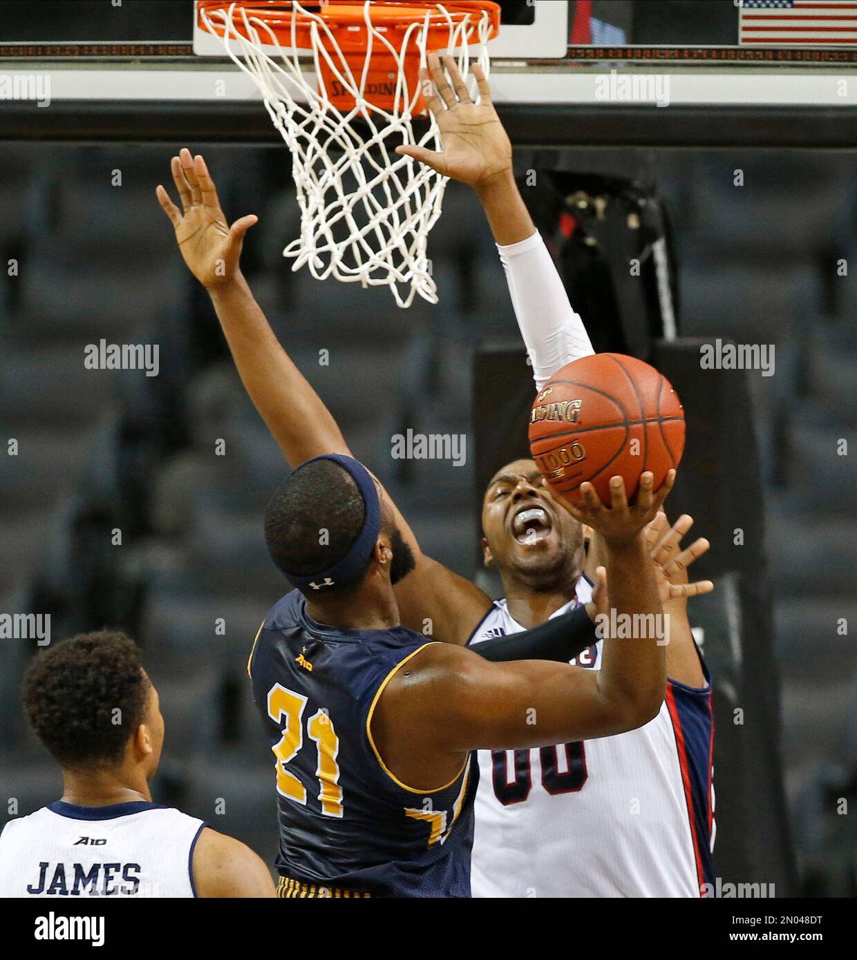 Duquesne center Darius Lewis (00) defends as La Salle guard Jordan ...