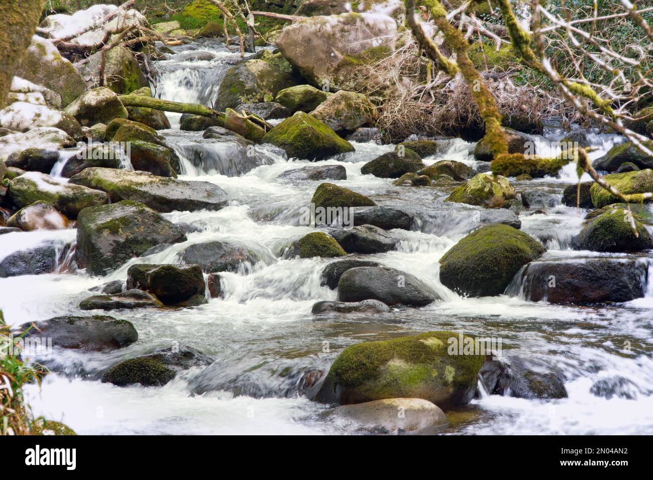 Waters cascade over rocks on the River Meavy at Shaugh Bridge in South ...