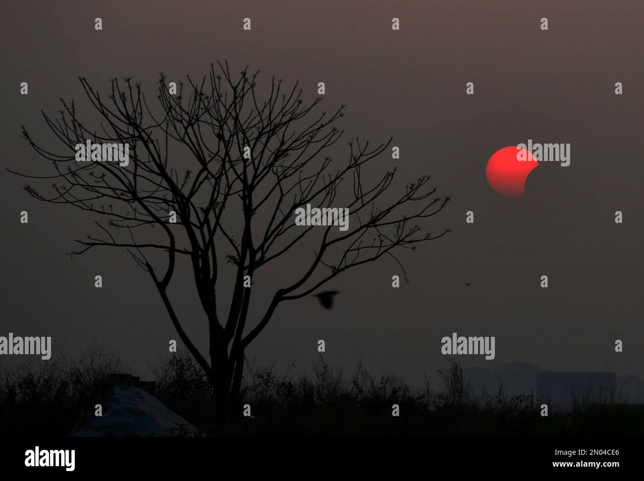 A partial solar eclipse is seen from Dhaka, Bangladesh, Wednesday, March 9, 2016. Bangladeshi ...