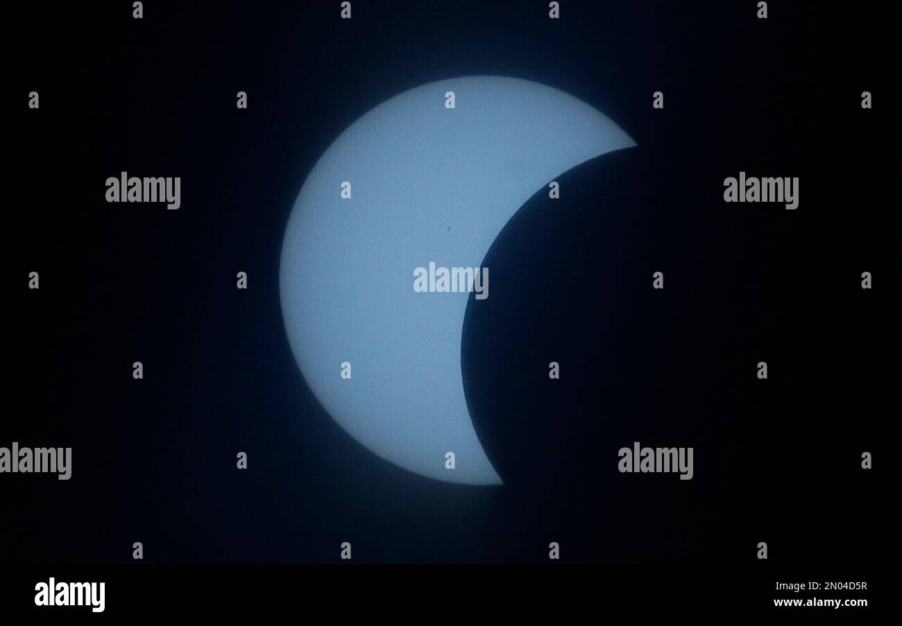 A partial solar eclipse occurs Wednesday, March 9, 2016 as seen from ...