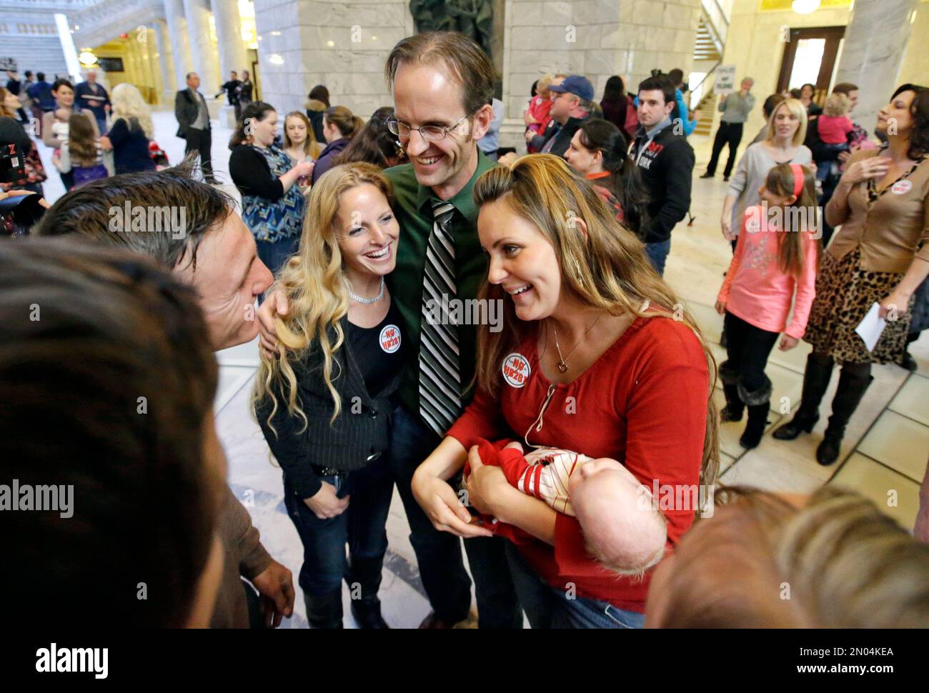 Polygamy advocate Enoch Foster, center, poses with his wives Catrina ...