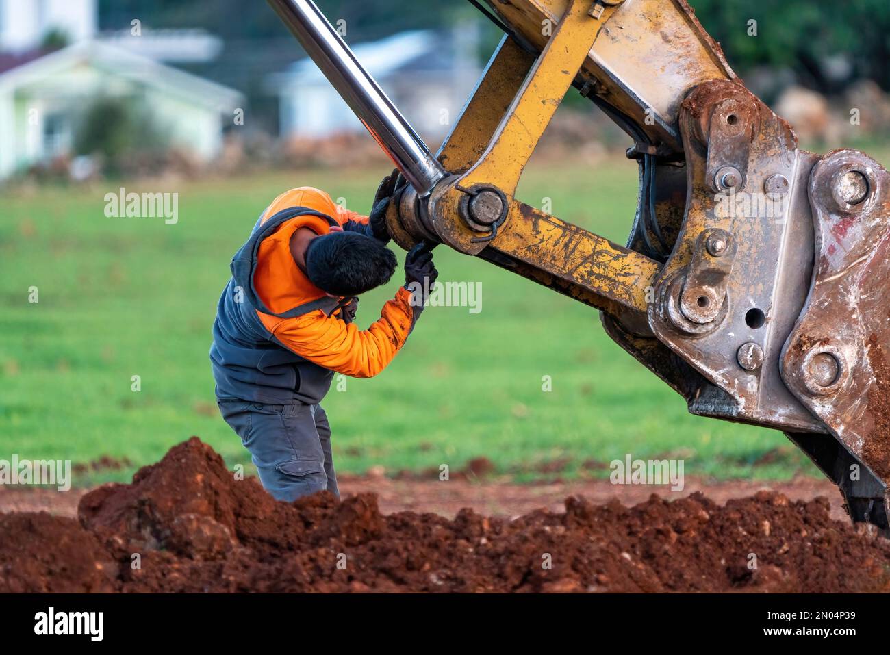 Excavator maintenance and repair operator doing repairs and maintenance ...