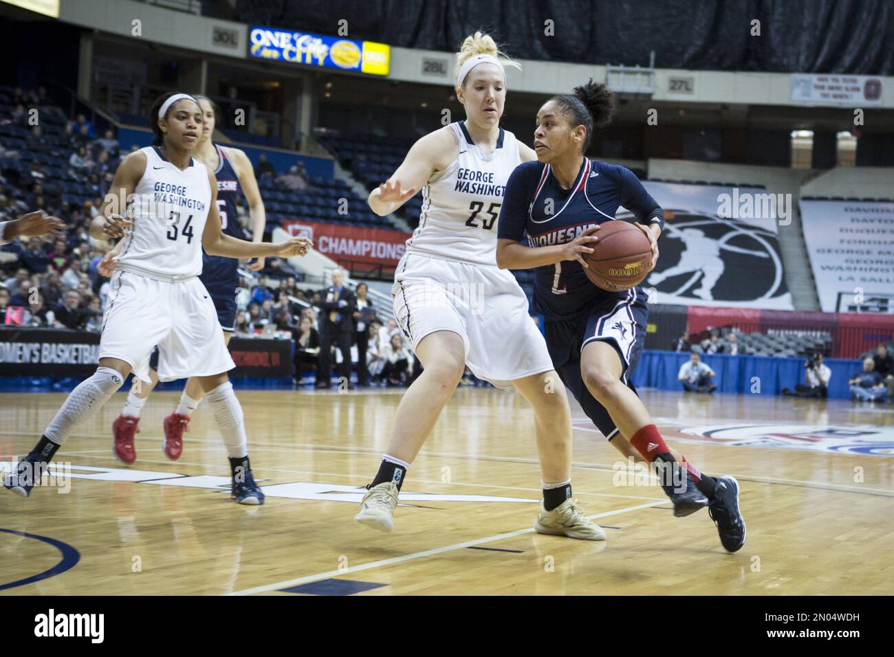 Duquesne's Deva'Nyar Workman (2) drives the ball past George Washington ...